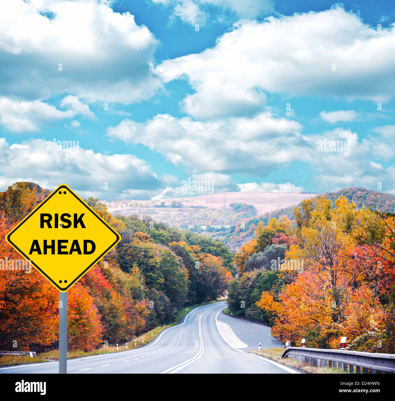 "RISK AHEAD" sign against road - Business concept Stock Photo - Alamy