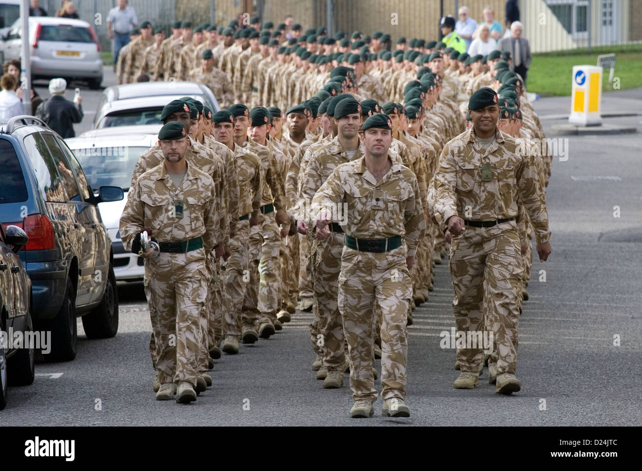 A column of British soldiers marching through Croydon at a welcome home ...