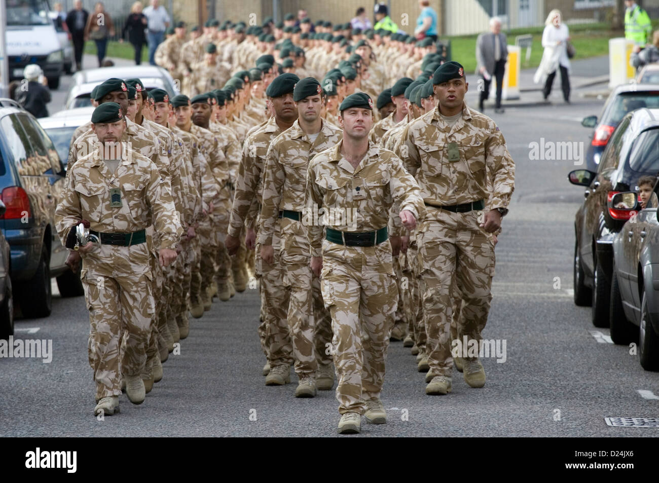 A column of British soldiers marching through Croydon at a welcome home ...