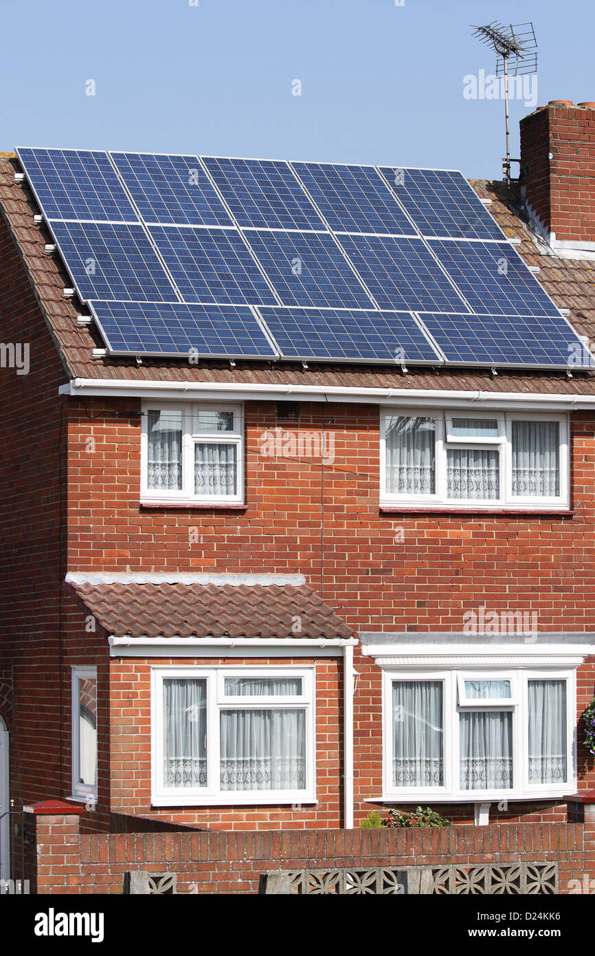 Solar photovoltaic panels on brick house roof Stock Photo - Alamy