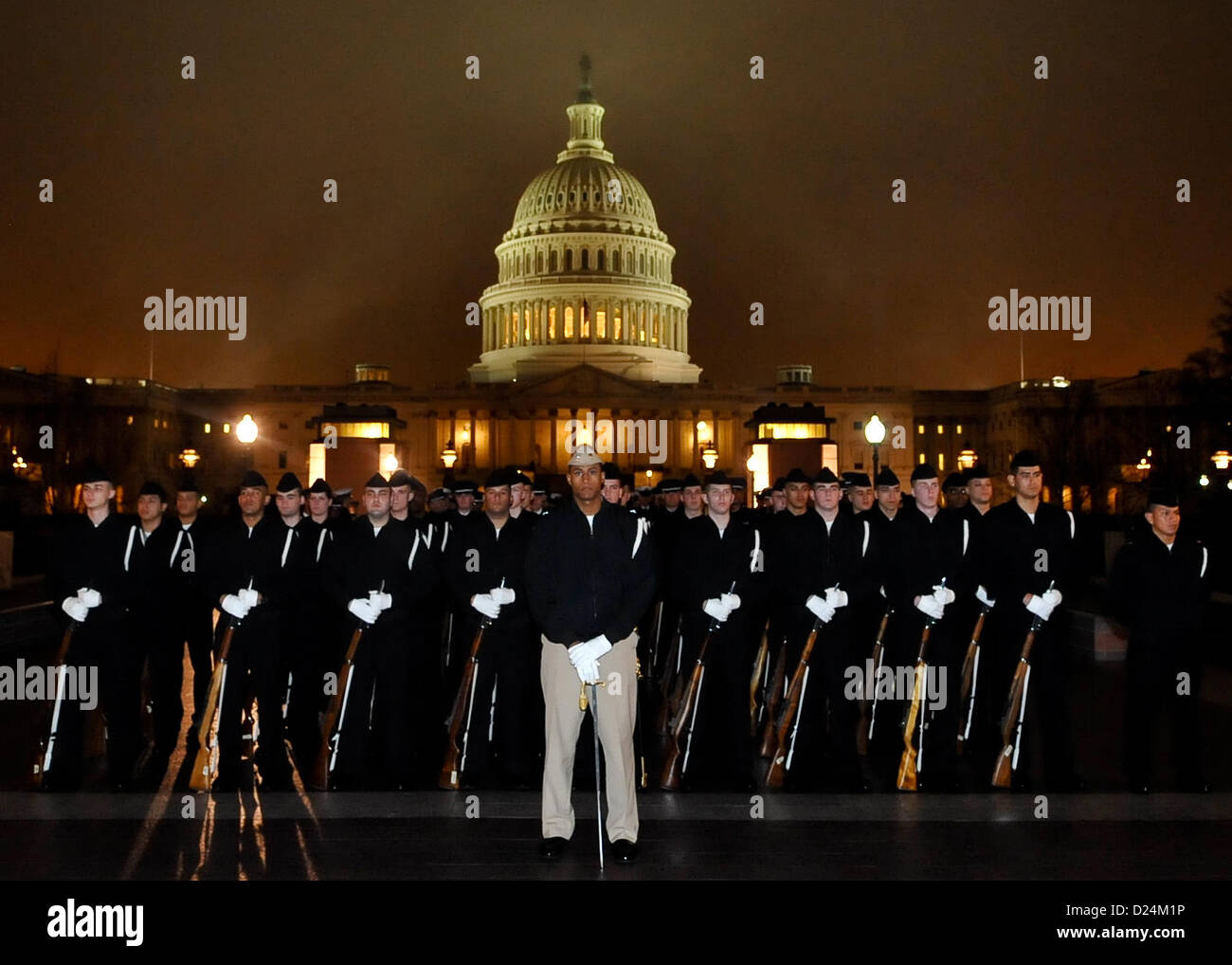 Members of the U.S. Navy honor guard stand in formation in front of the ...