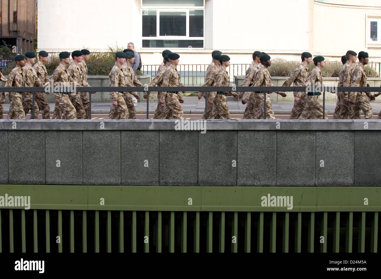 A column of British soldiers marching through Croydon at a welcome home ...