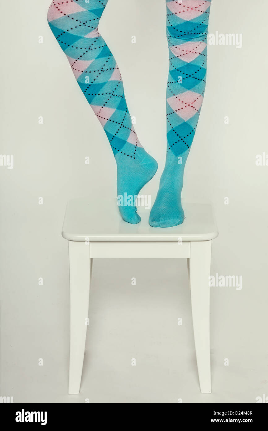 legs of a woman in burlington socks on a white stool Stock Photo - Alamy