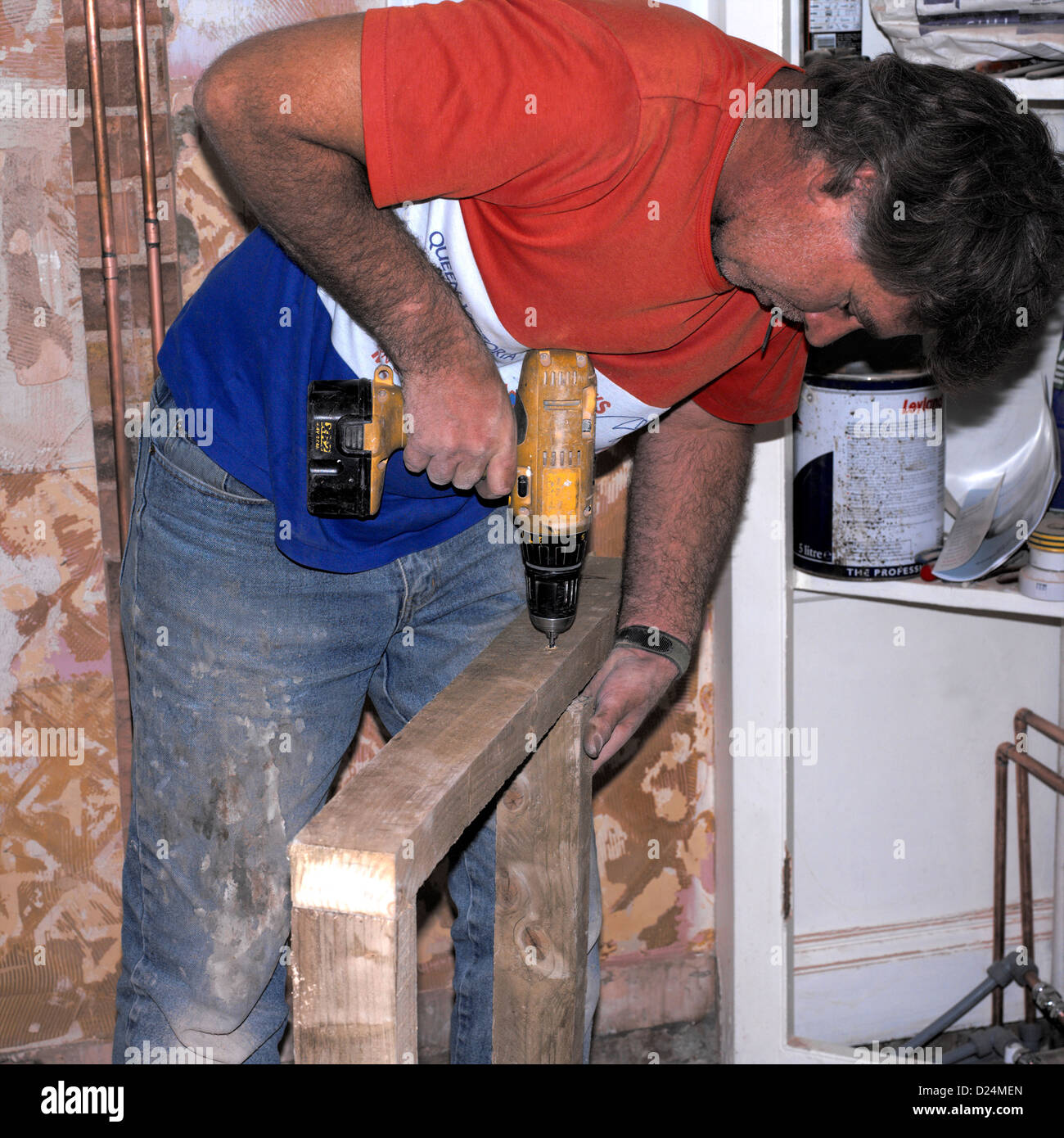 Plumber Building Wooden Frame for Shower Tray Using Power Drill in New ...