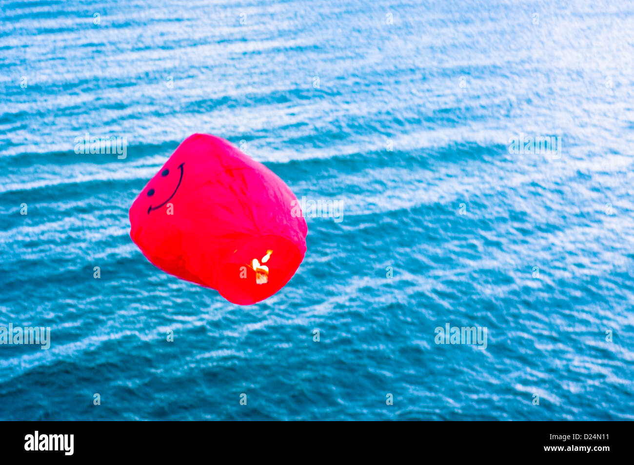 An image of red hot air balloon over the sea Stock Photo - Alamy
