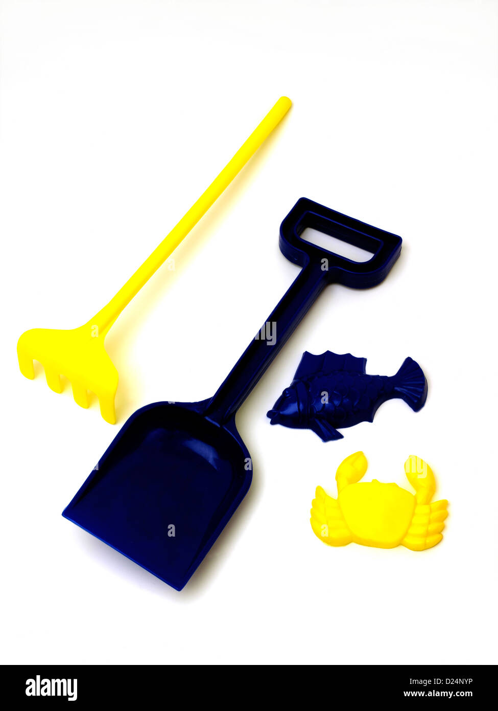Blue Plastic Spade Yellow Plastic Rake and Sand Shapes Stock Photo - Alamy