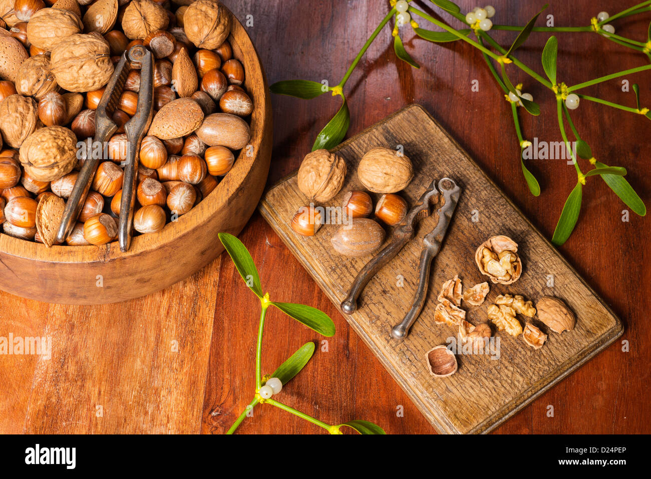 Edible nuts and nutcrackers on a table at home with mistletoe in a ...