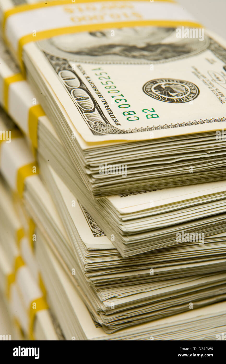 Stacks of $100 bills banded in $10,000 amounts with a yellow band Stock ...