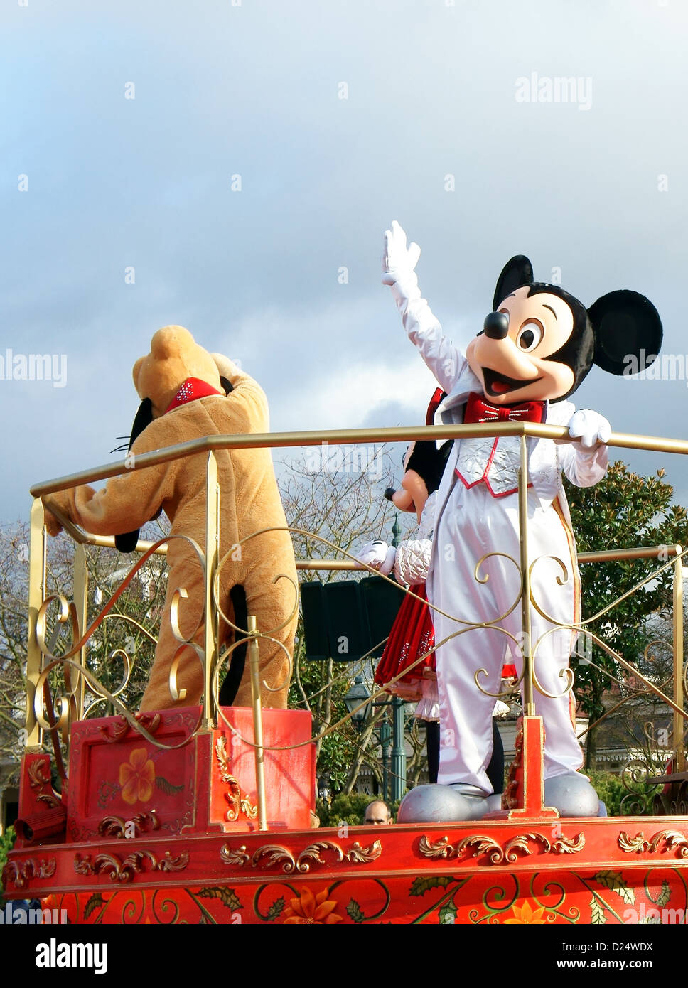 Mickey Mouse and other Disney characters waving to the crowd during the ...