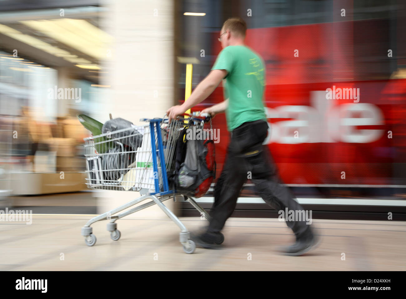 Berlin, Germany, a man pushing a cart full before them Stock Photo - Alamy