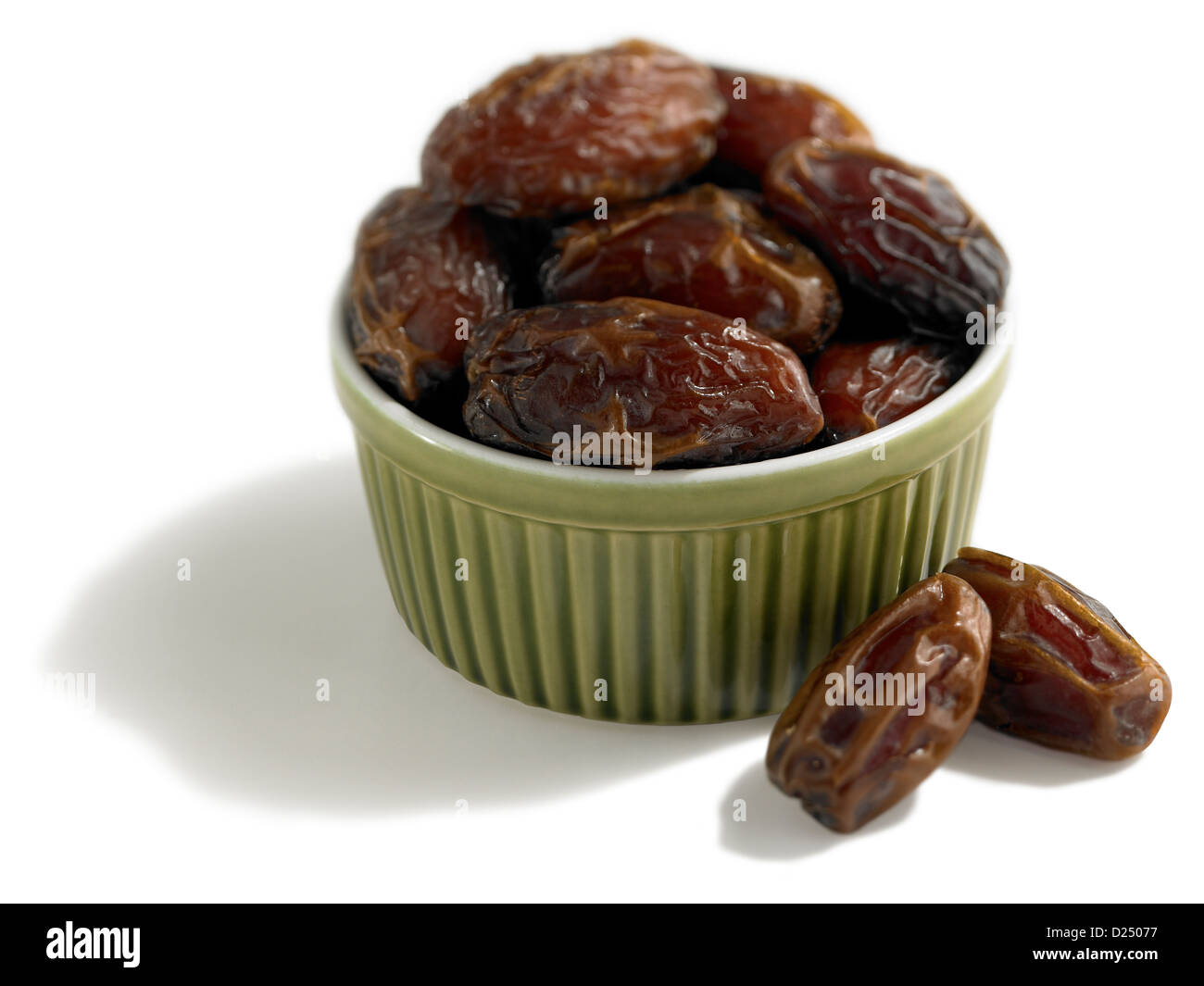 Dates in a bowl outlined on white Stock Photo - Alamy
