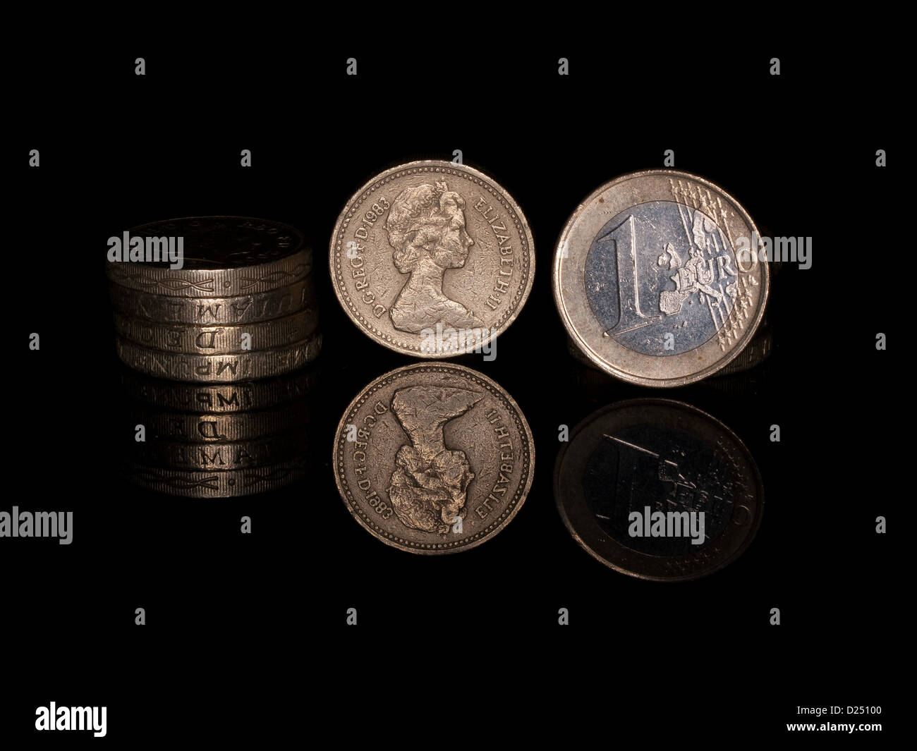 Pound and Euro coins on Black Stock Photo - Alamy