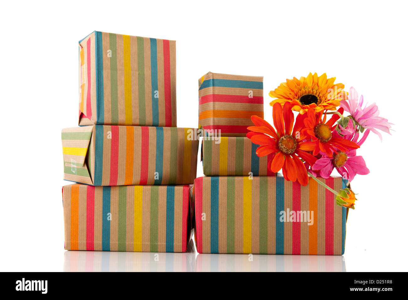 colorful stack with wrapped presents and flowers isolated on white ...
