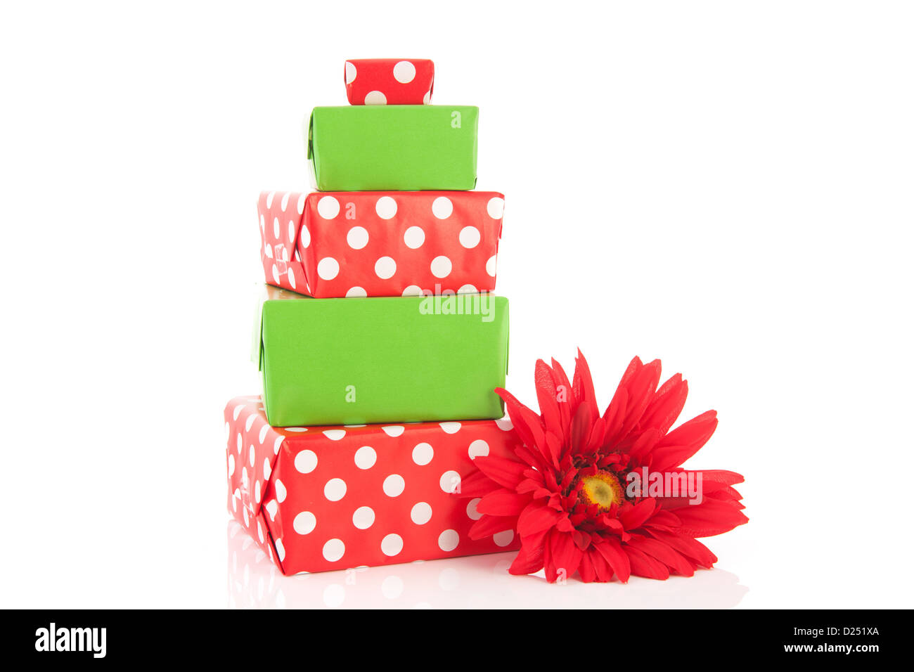 Stack with red and green gifts and flower Stock Photo - Alamy