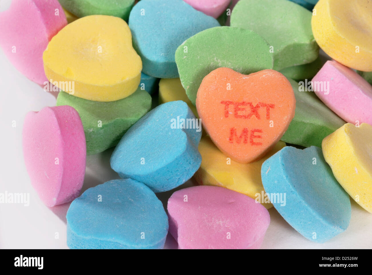 Valentine candy hearts with "Text Me" saying Stock Photo - Alamy