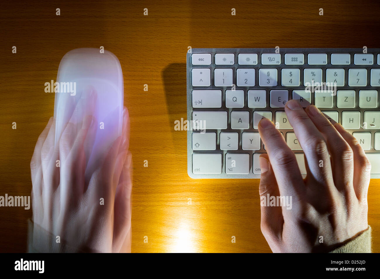 Person is working with a desktop computer. Using keyboard an mouse ...