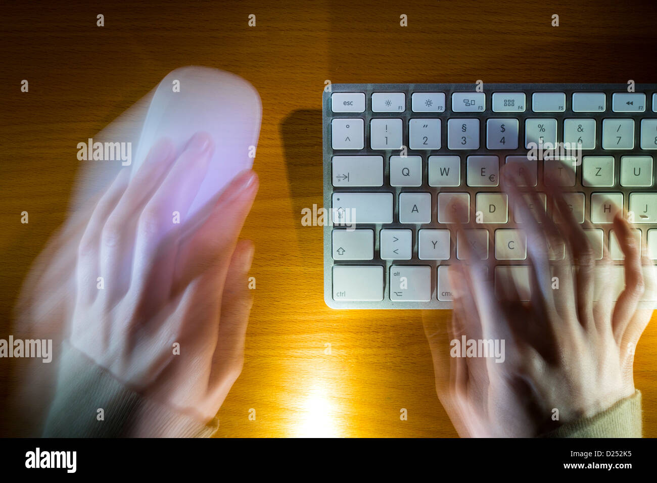 Person is working with a desktop computer. Using keyboard an mouse ...