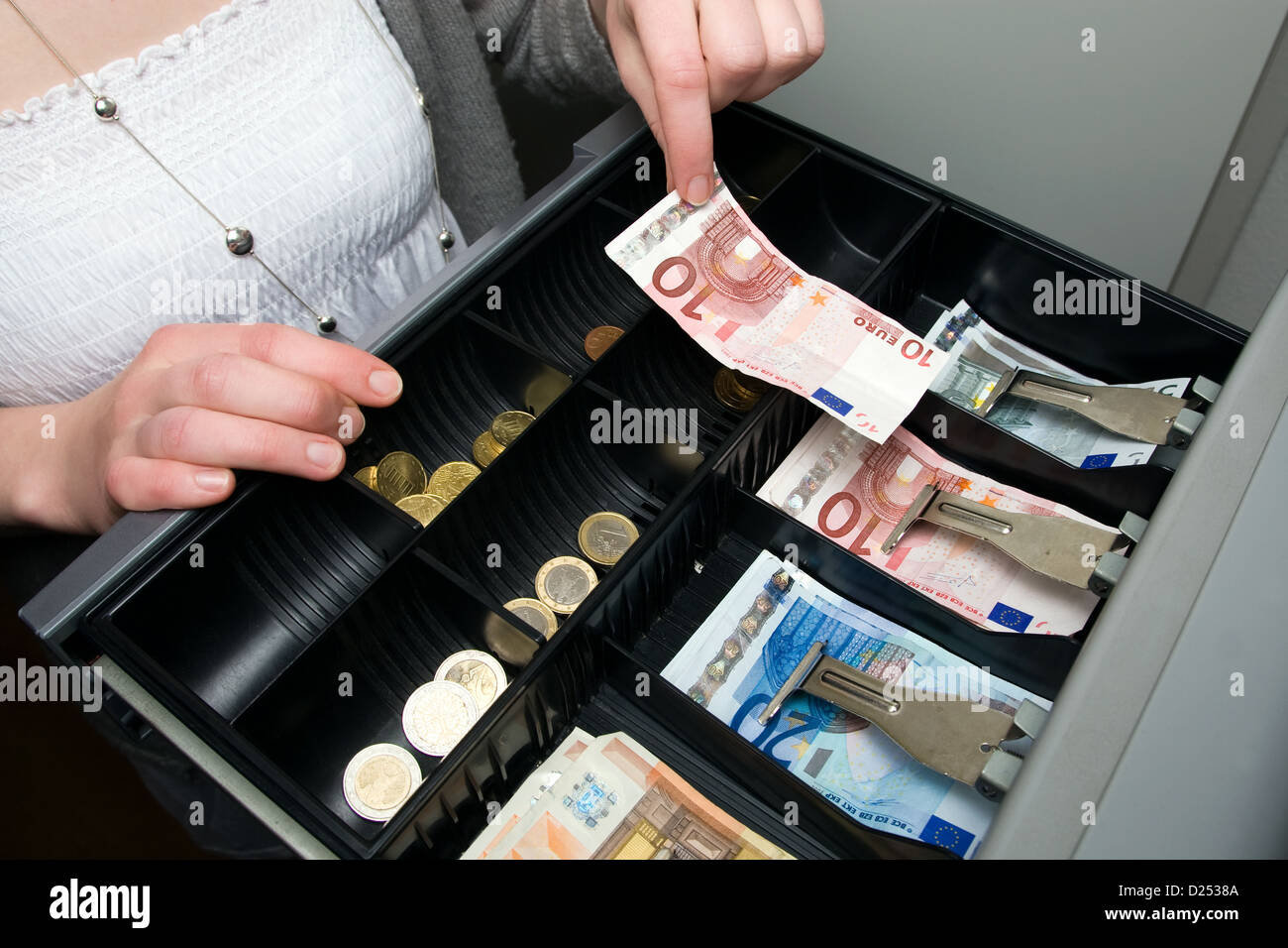 Berlin, Germany, workers change takes money out of the cash register ...