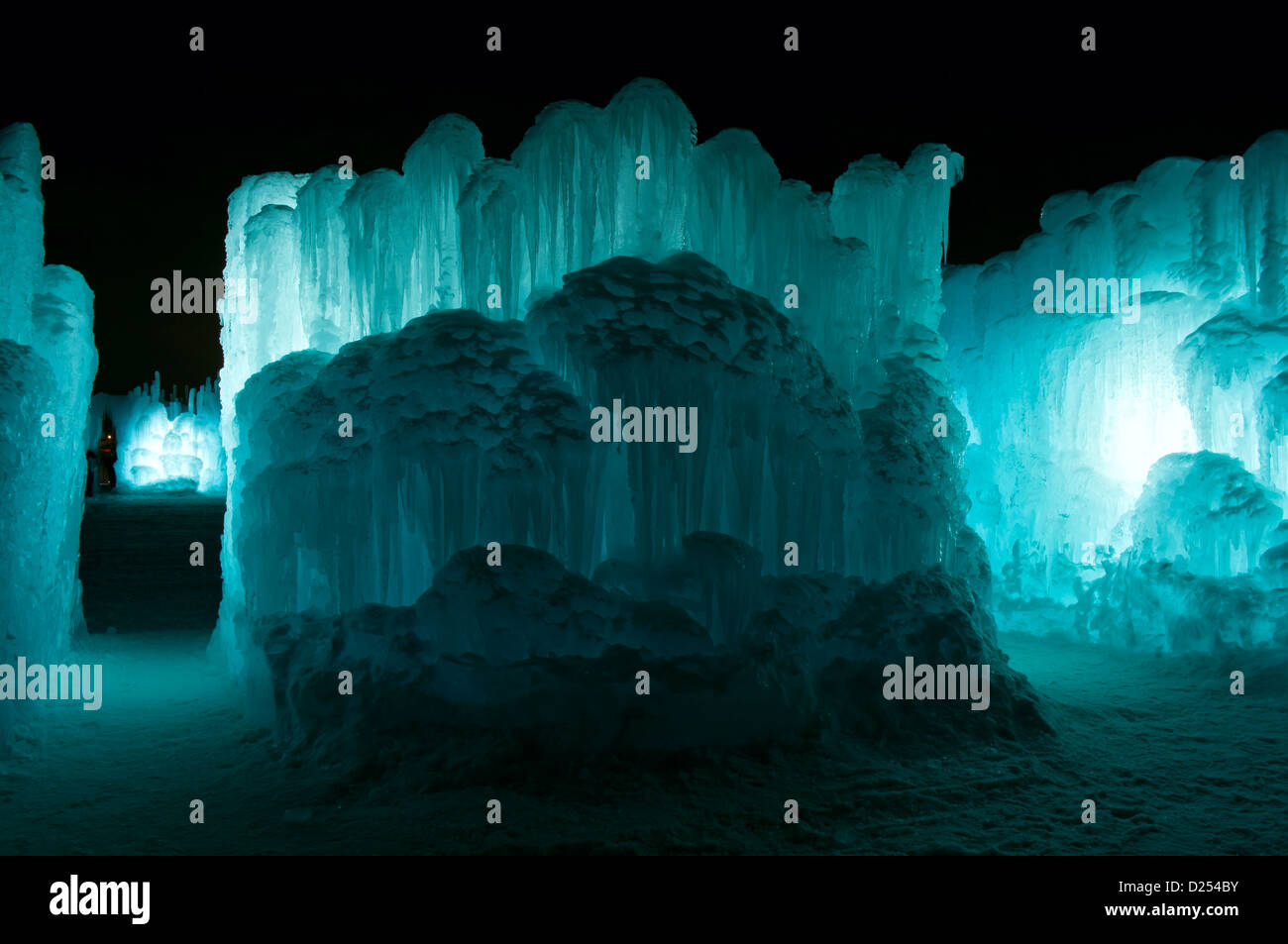 Illuminated walls of ice and icicles with passages between under night ...