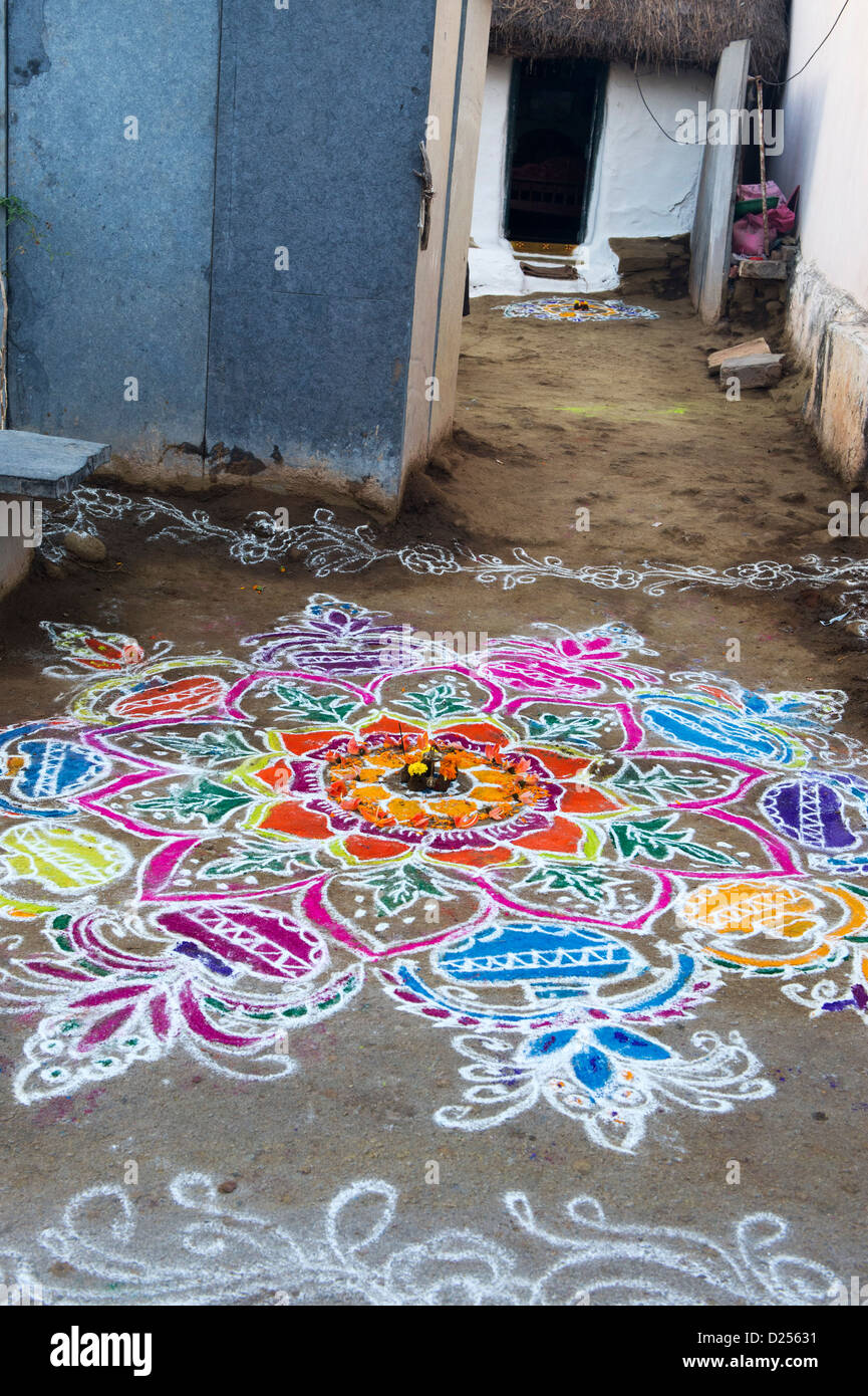 Rangoli coloured powder design in a rural Indian village street during ...