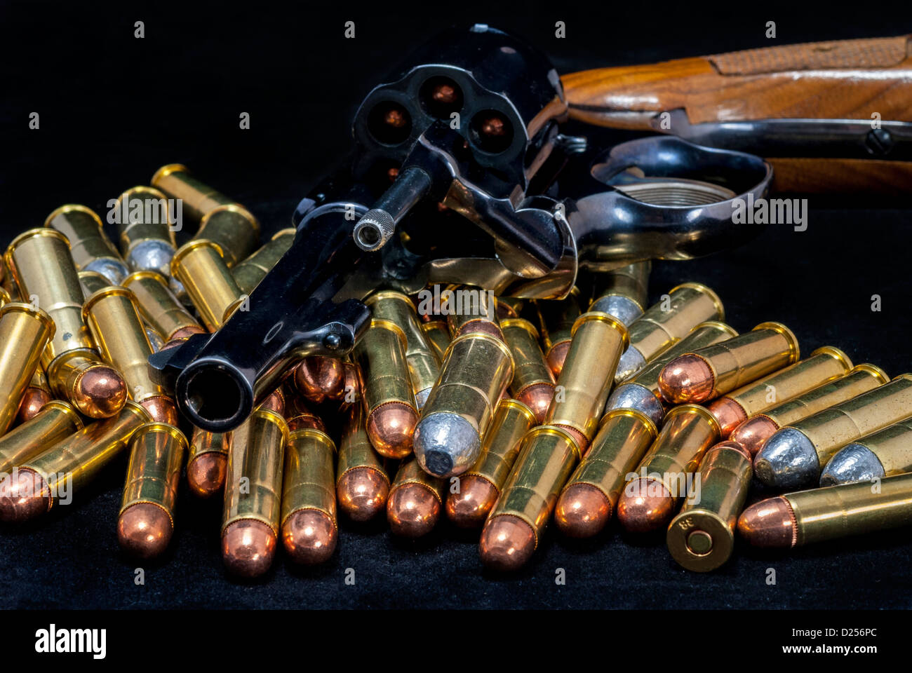 Pistol with bullets in it on a black background Stock Photo - Alamy