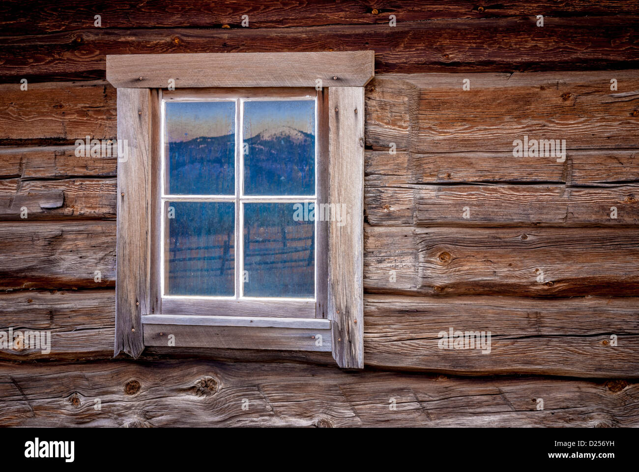 Rustic Log cabin and window with a reflection of a mountain range Stock ...