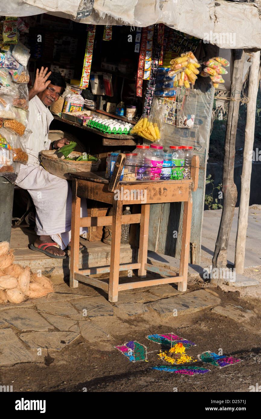 Indian man waving in a rural Indian street shop / shack . Andhra ...