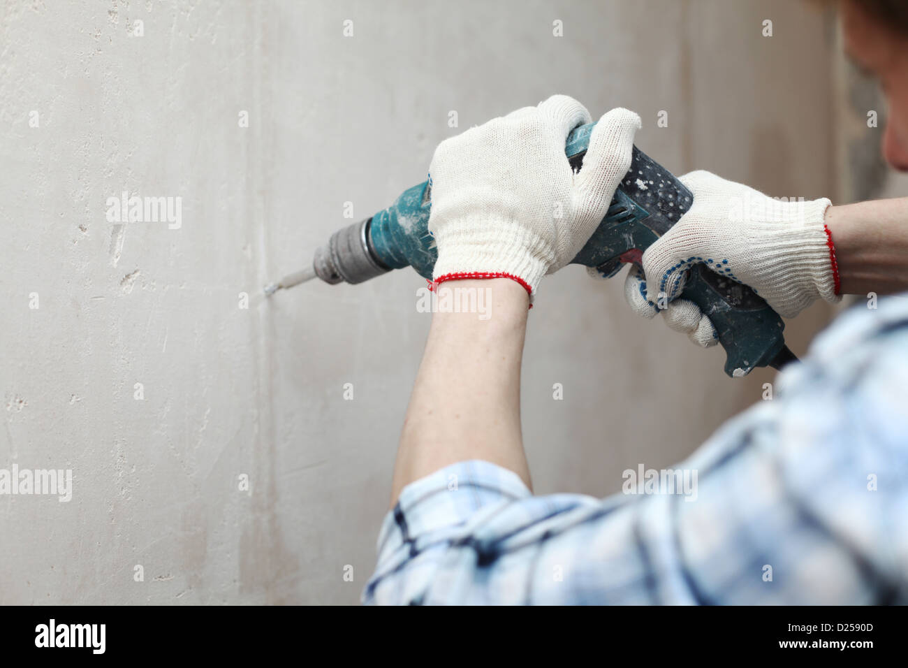 man worker hammer drills wall Stock Photo - Alamy