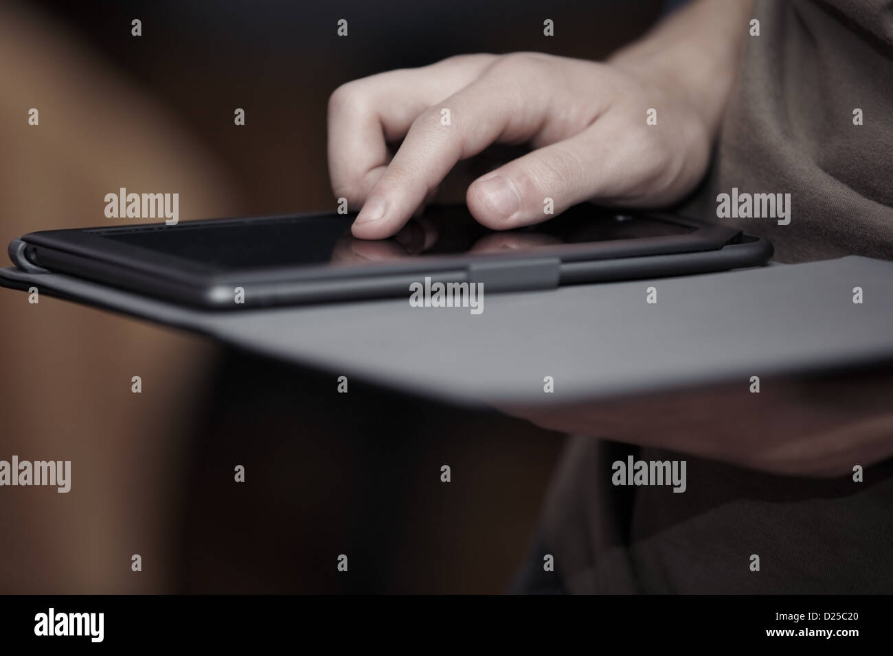 Hands of person using black tablet computer Stock Photo - Alamy