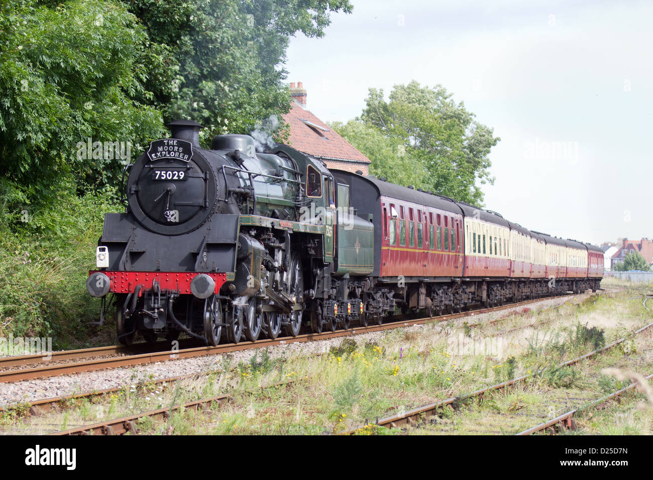 Steam locomotive pulling a passenger train on the North Yorkshire Moors ...