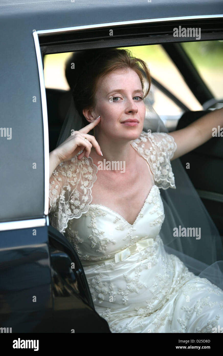 Beautiful the bride in car Stock Photo - Alamy