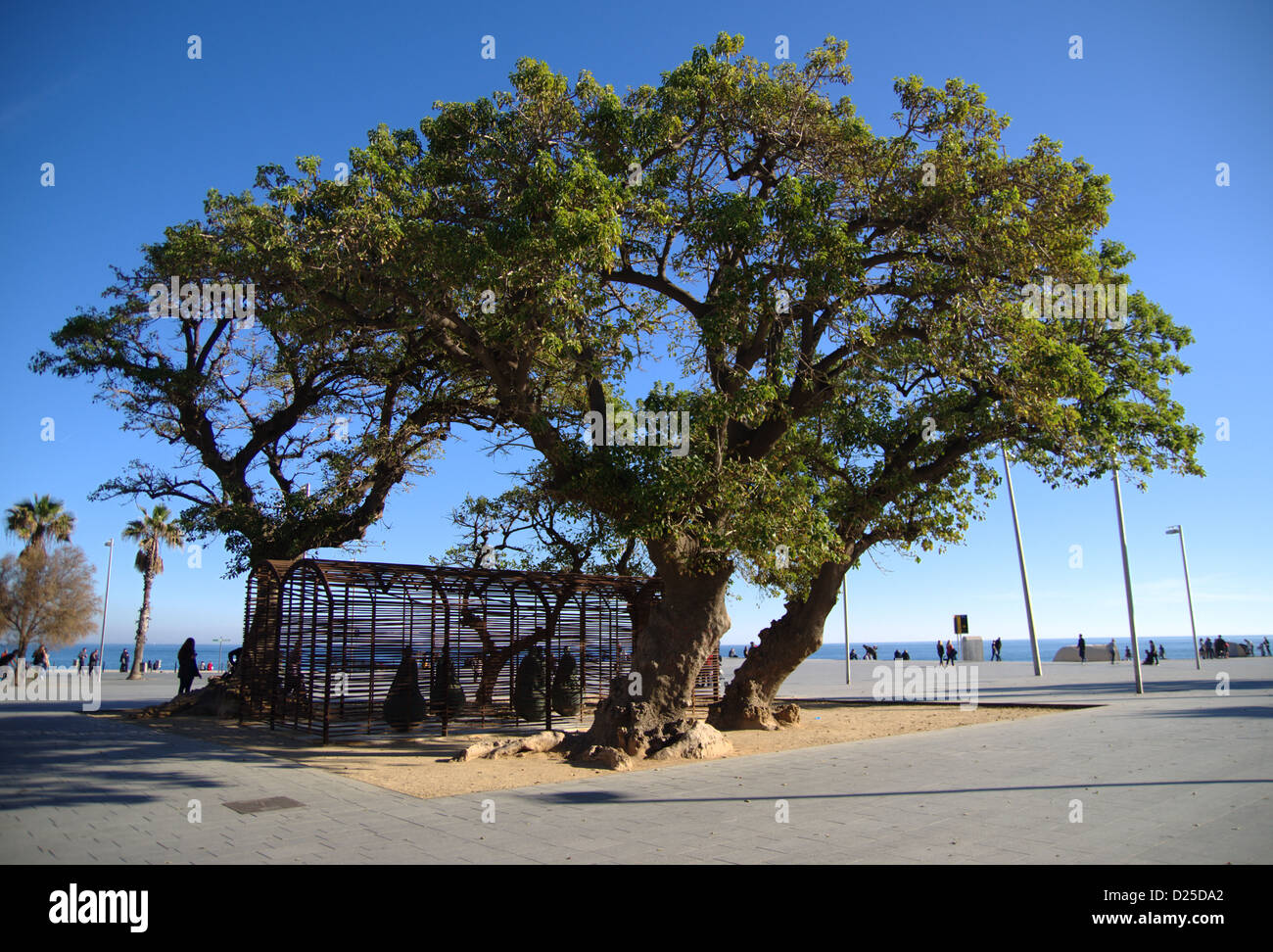 Trees and a sculpture near the Barceloneta beach in Barcelona Stock ...