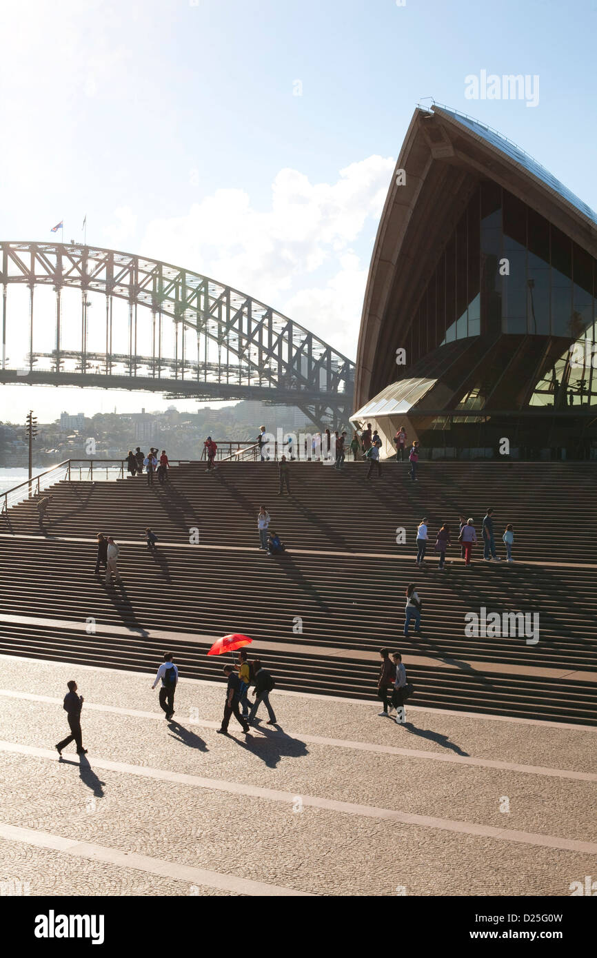 tourist walking on the steps in front of the Sydney Opera House in the ...