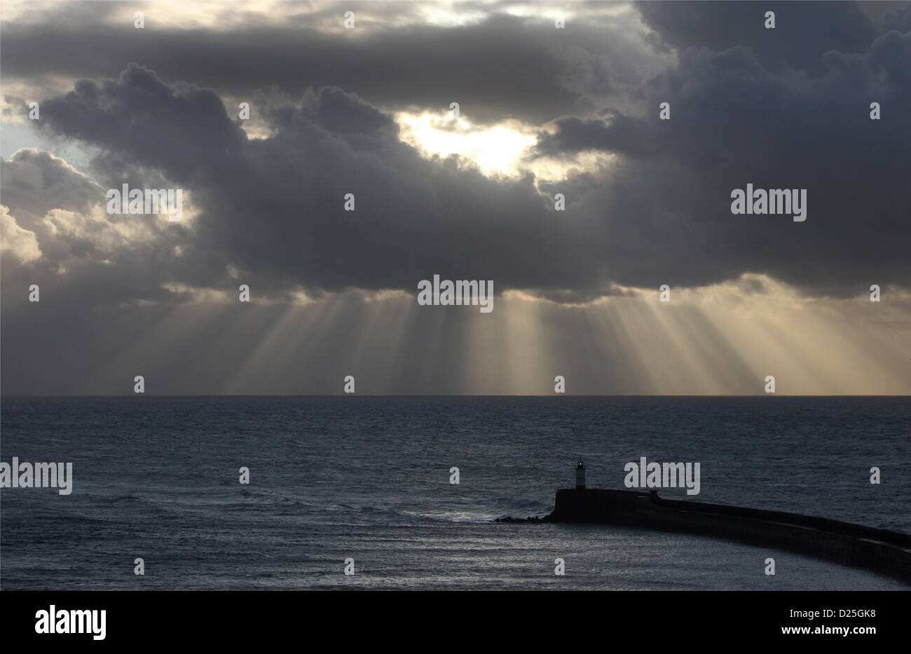 Rays of Sunlight filter through dark rain clouds over Newhaven ...