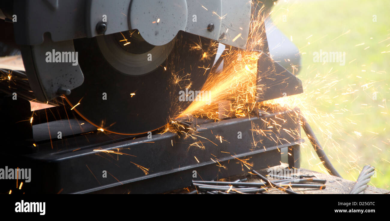 A worker operating a grinder Stock Photo - Alamy