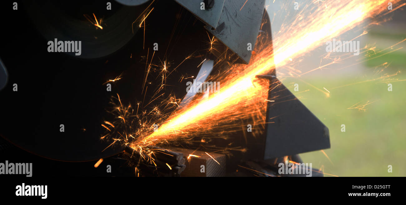 A worker operating a grinder Stock Photo - Alamy