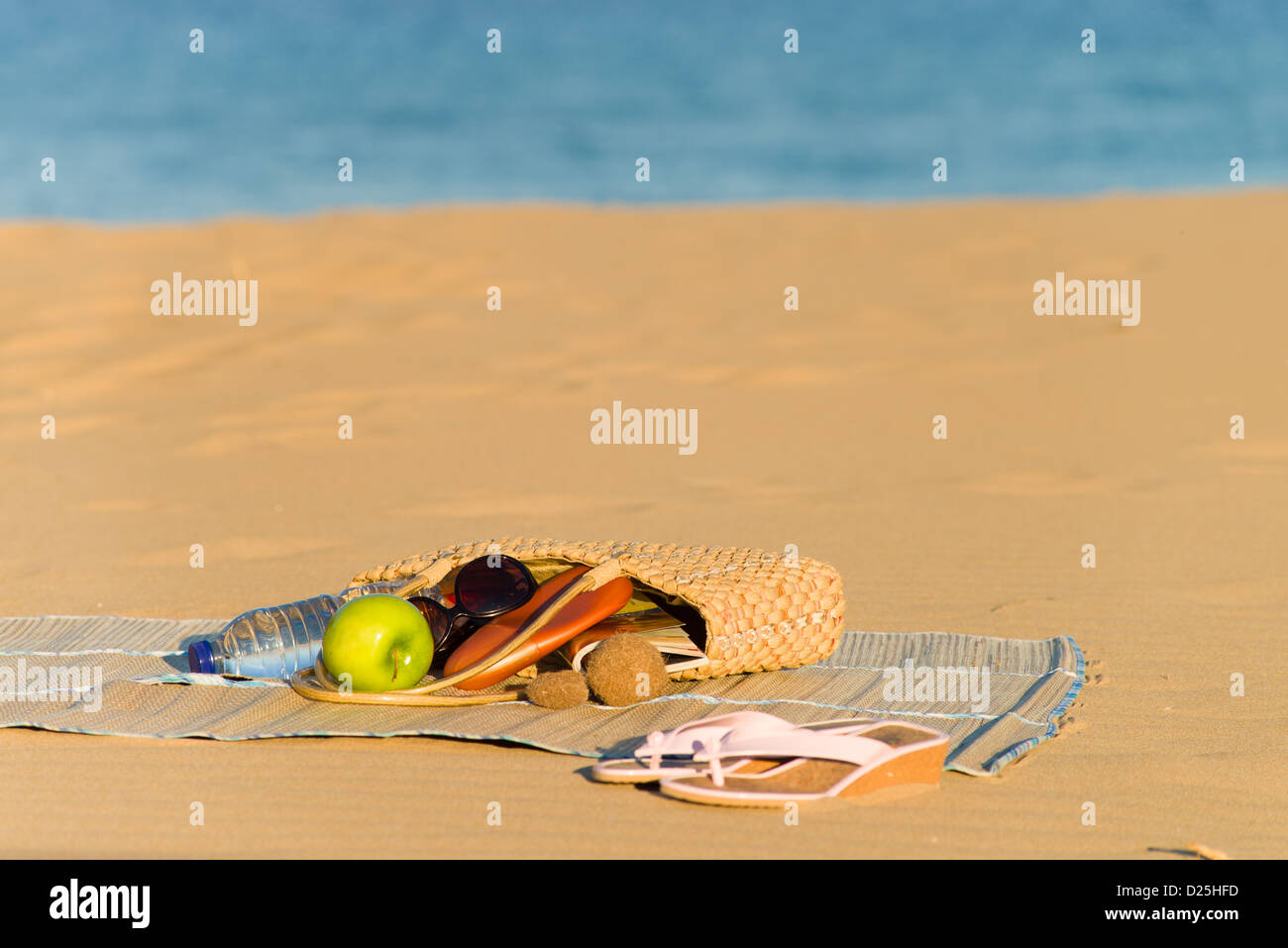 A handbag and summer related objects on a beach mat Stock Photo - Alamy