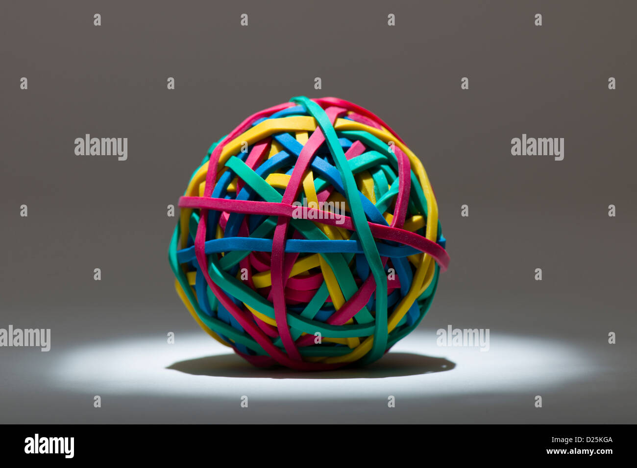 Colourful rubber band ball under spotlight Stock Photo - Alamy