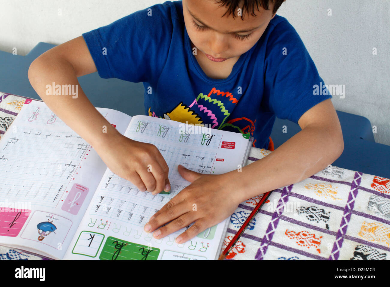 First-grader learning to write, using an eraser Stock Photo - Alamy