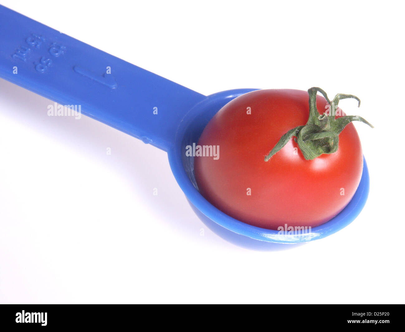 Tomato in measuring spoon Stock Photo - Alamy