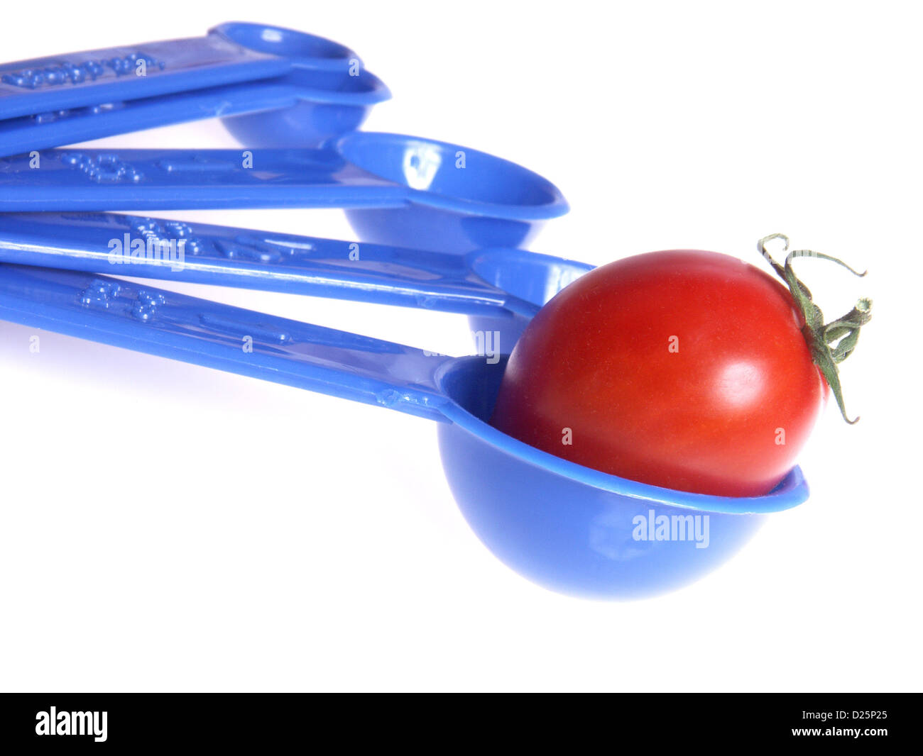 Tomato in measuring spoon Stock Photo - Alamy