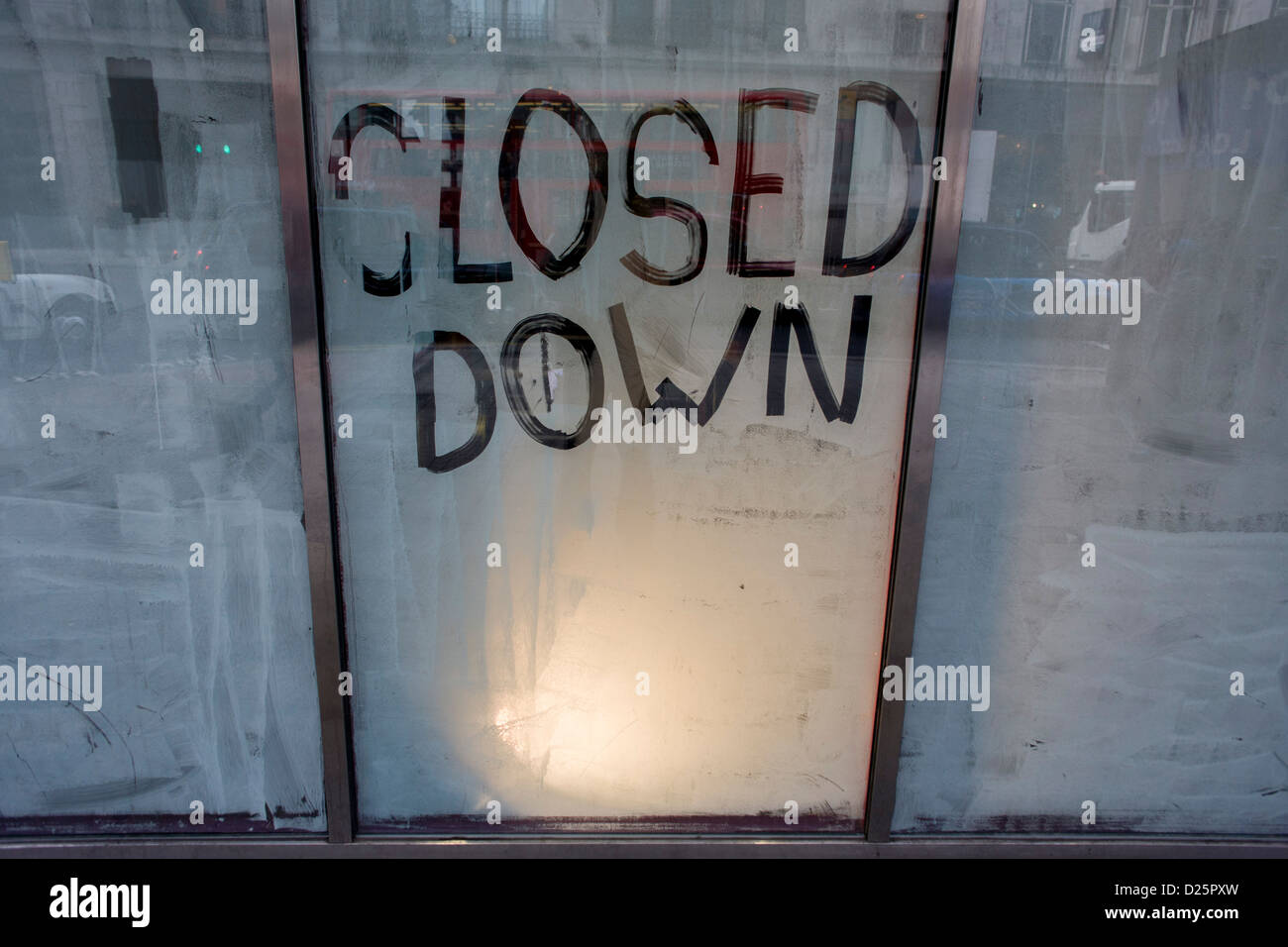 Closed Down is written on a paint-covered window of a generic business ...
