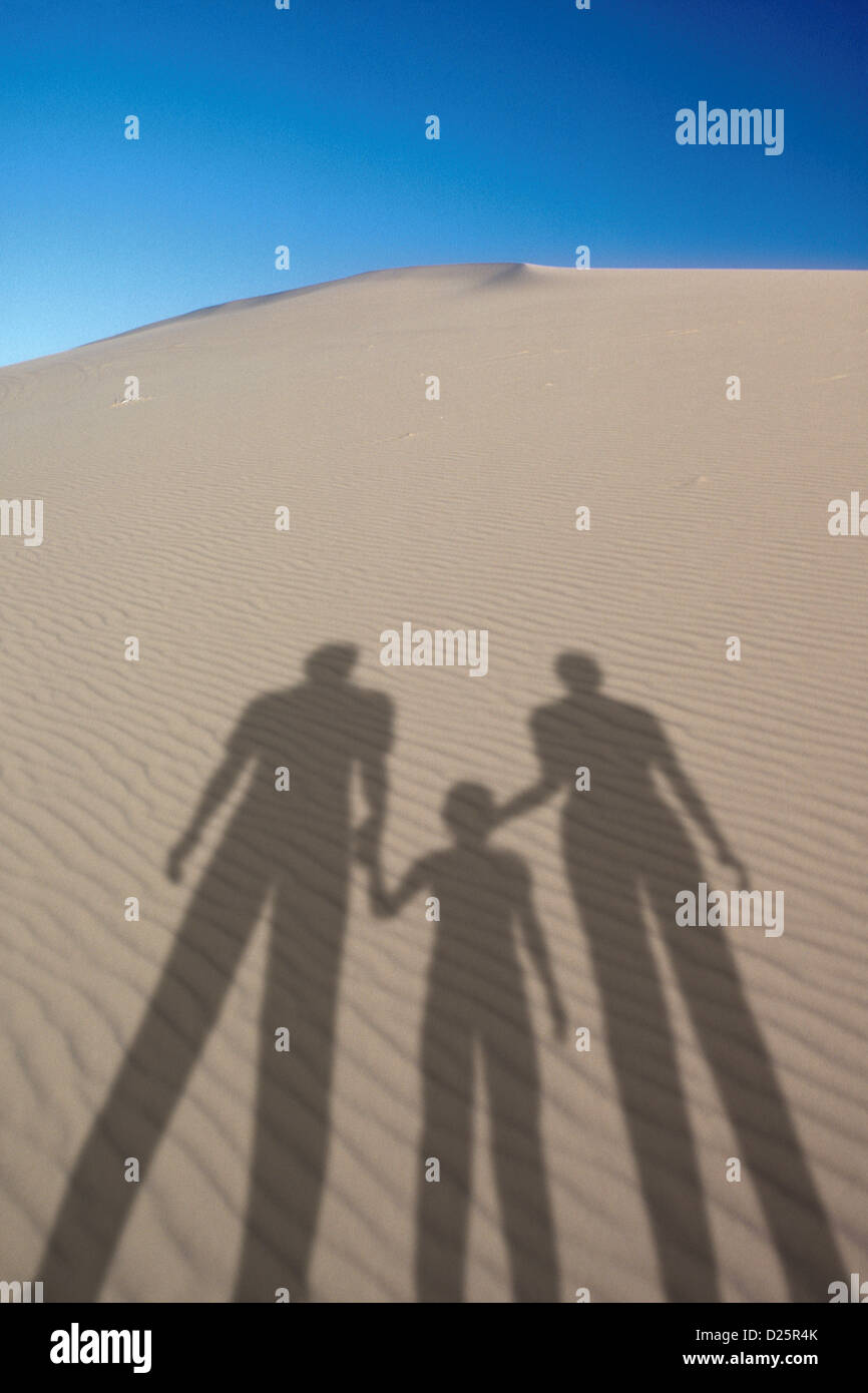 Three shadows holding hands hi-res stock photography and images - Alamy