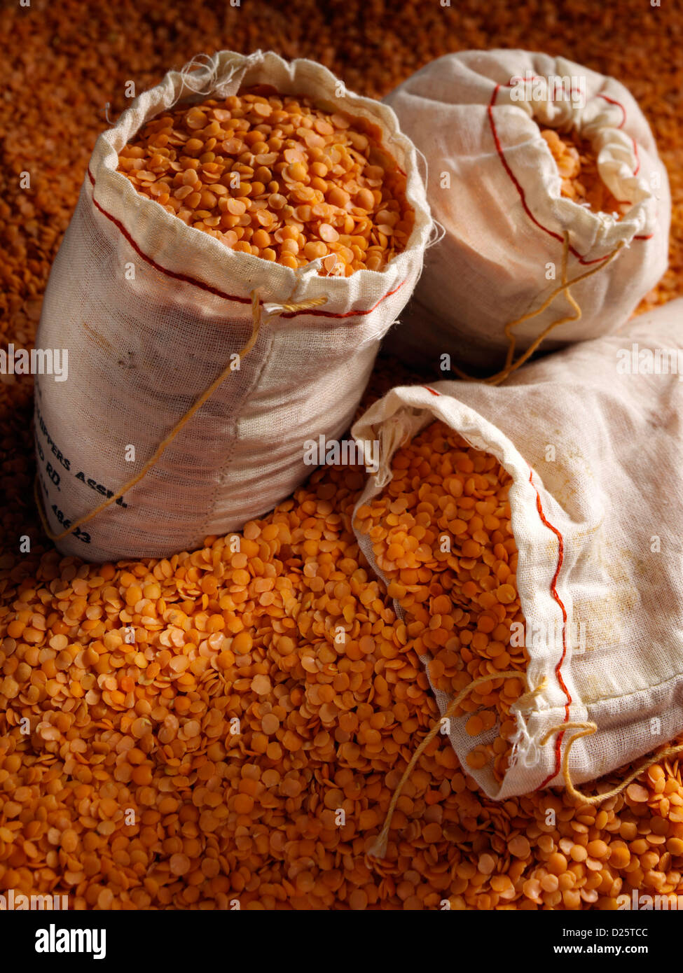 Entire frame red split lentils with sacks Stock Photo - Alamy