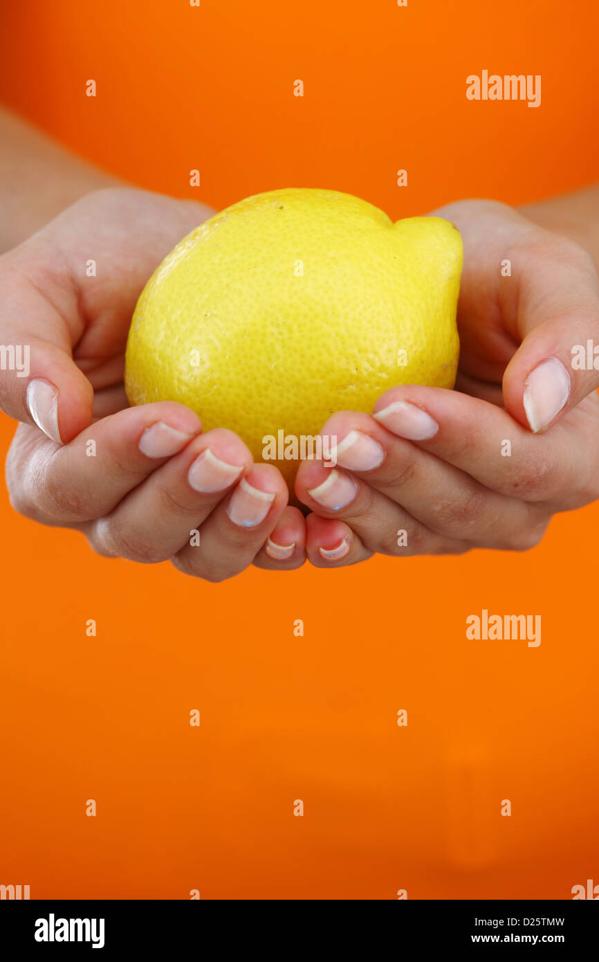 lemon in woman hands close up Stock Photo - Alamy