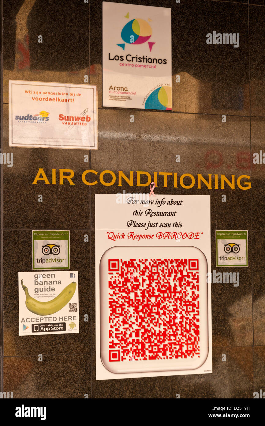 Quick response barcode and other signs stuck on wall outside a ...