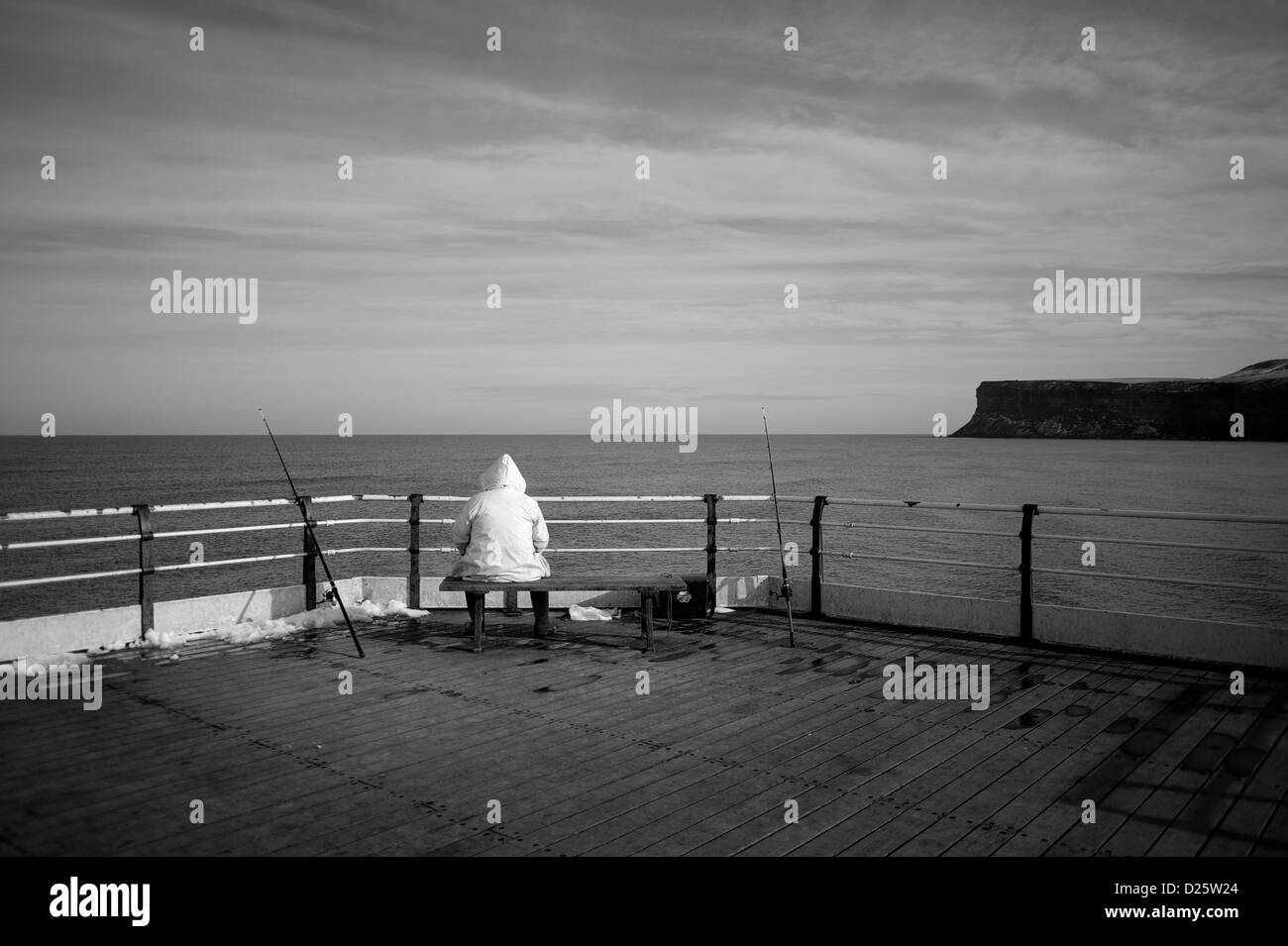 A man sits fishing on the pier at Saltburn in Cleveland Stock Photo - Alamy