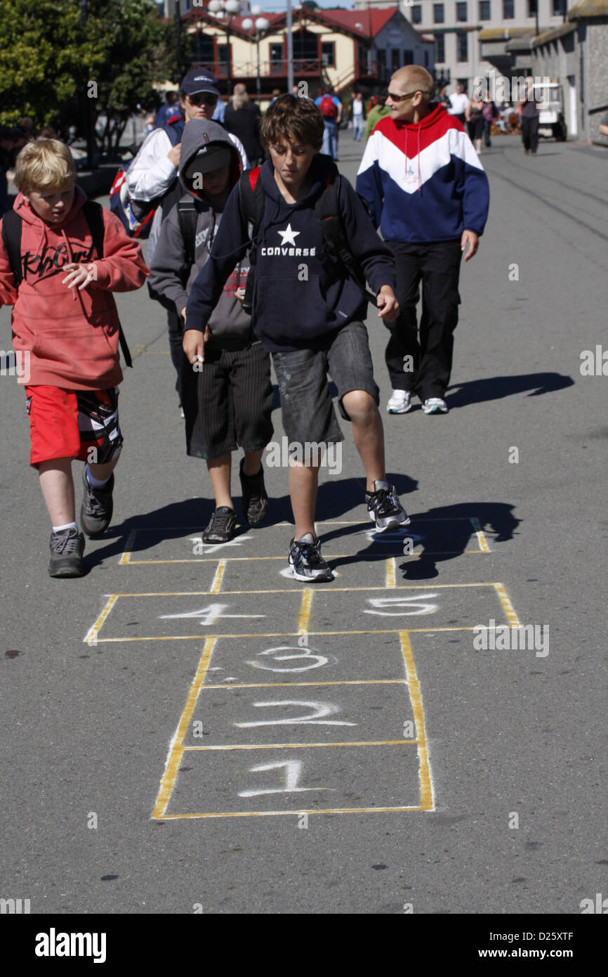 Children on a step-jump on the pavement in Lambton Harbour, Wellington ...