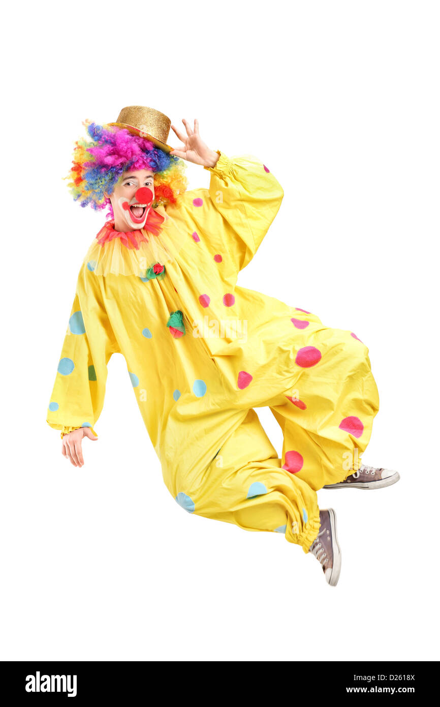 Full length portrait of a male clown jumping and gesturing isolated on ...