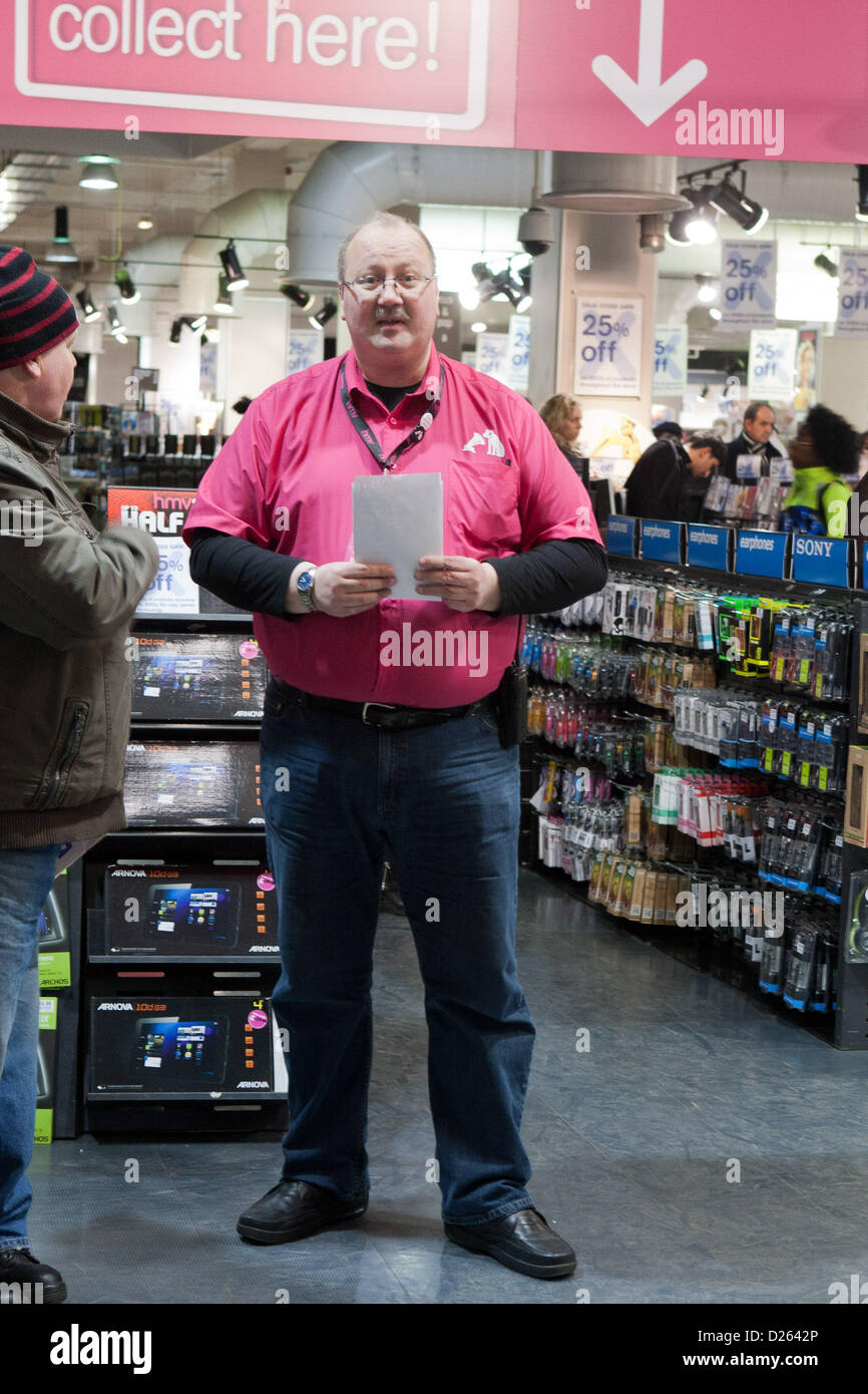 Staff member hands out 25% off blue cross sale flyers at HMV Flagship ...